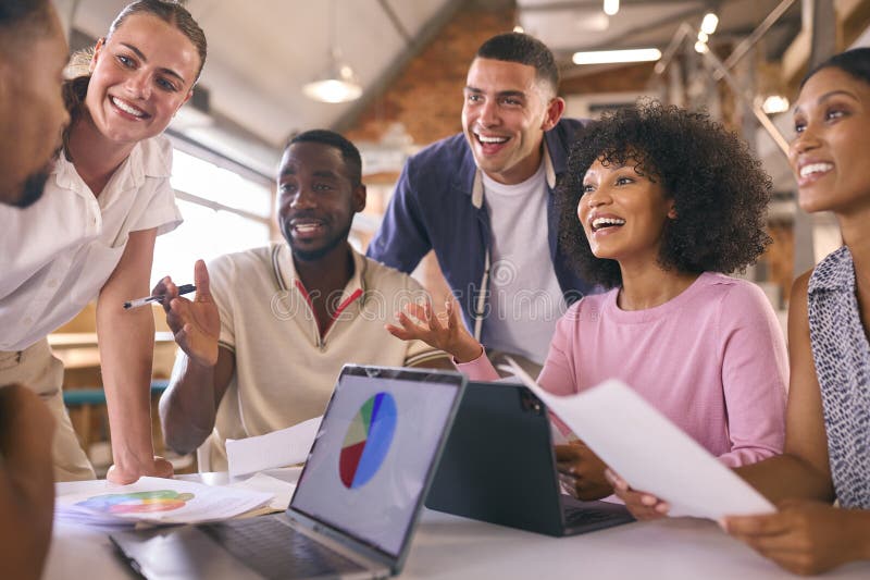 Multi-Cultural Business Team Meeting Around Desk in Modern Open Plan ...