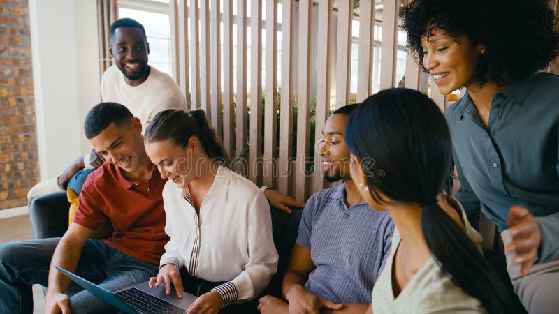 Multi-Cultural Business Team Sitting on Couch in Modern Open Plan ...