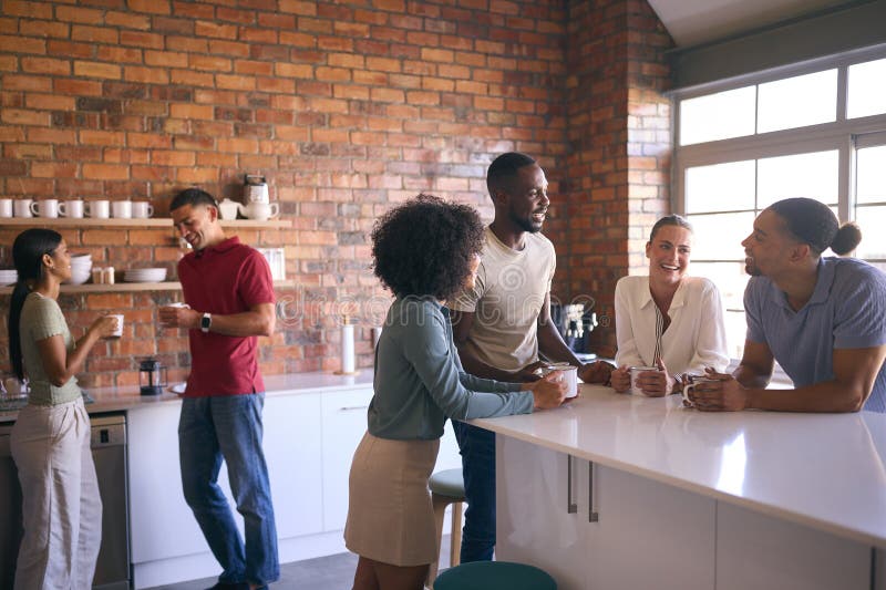 Multi-Cultural Business Team Taking Coffee Break in Kitchen Area of ...