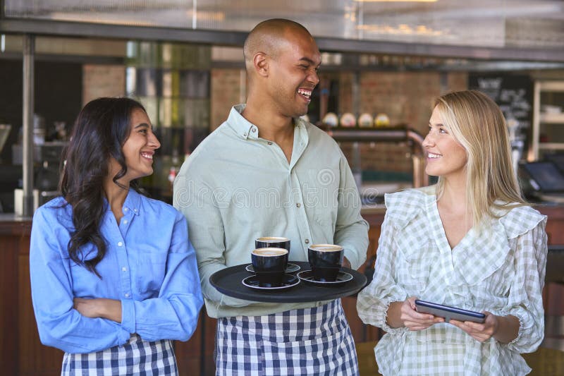 Multi-Cultural Staff Team with Digital Tablet Working in Restaurant or ...