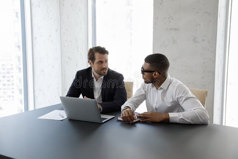 Multi Ethnic Business Partners Working on Collaborative Project at ...