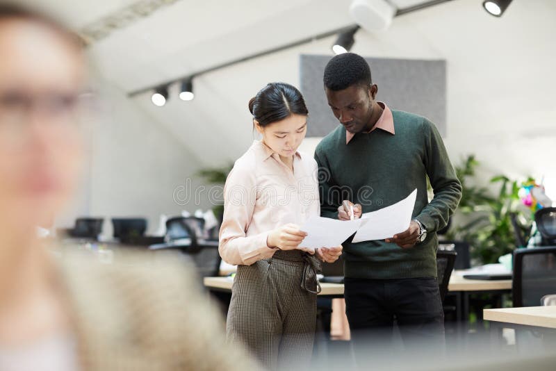 Multi-Ethnic Business People Discussing Documents Stock Photo - Image ...