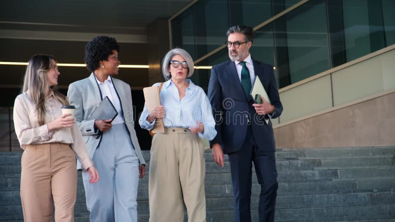 Businesspeople Walking and Talking on Office Building Stairs Stock ...