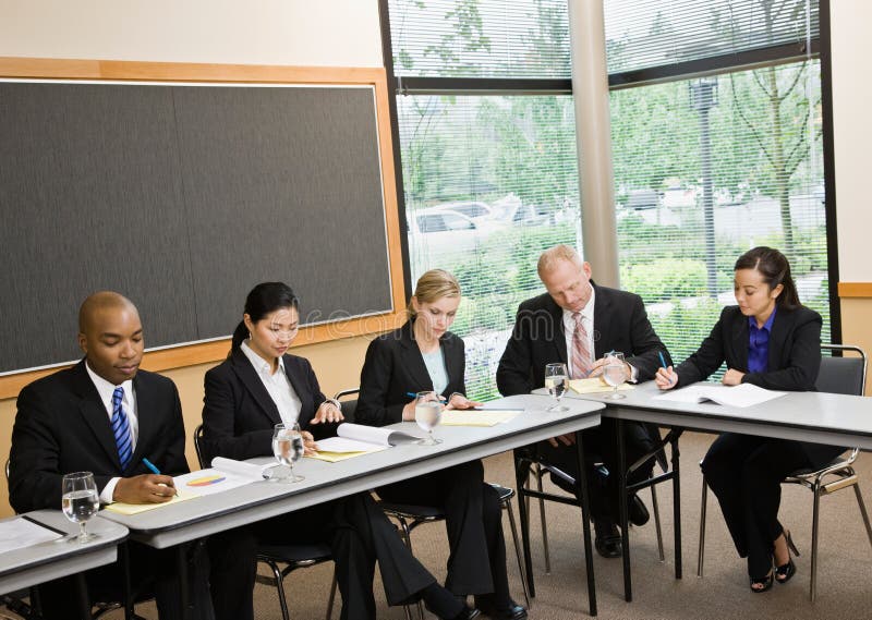 Multi-ethnic Co-workers Sitting Around Table Stock Photo - Image of ...
