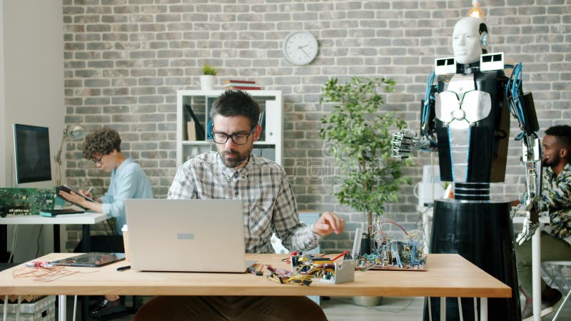 Multi-ethnic Creative Team Designing Robot in Office Using Computer ...