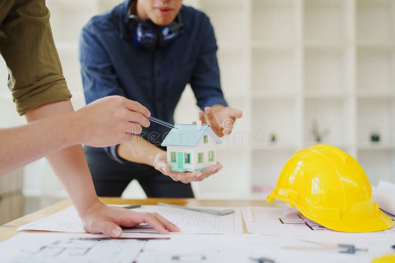 Engineers Discuss Building on Blueprint Drawing, Design Building ...