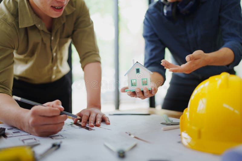 Engineers Discuss Building on Blueprint Drawing, Design Building ...