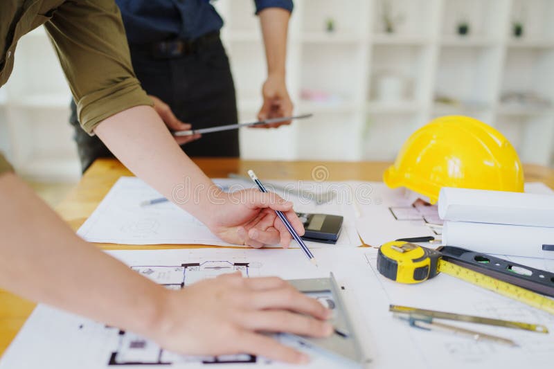 Engineers Discuss Building on Blueprint Drawing, Design Building ...