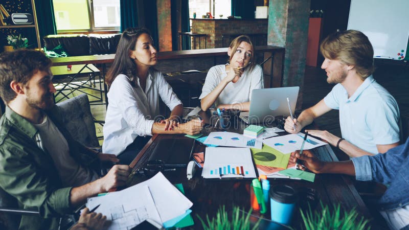 Multi-ethnic Group of Colleagues is Discussing Charts and Graphs ...