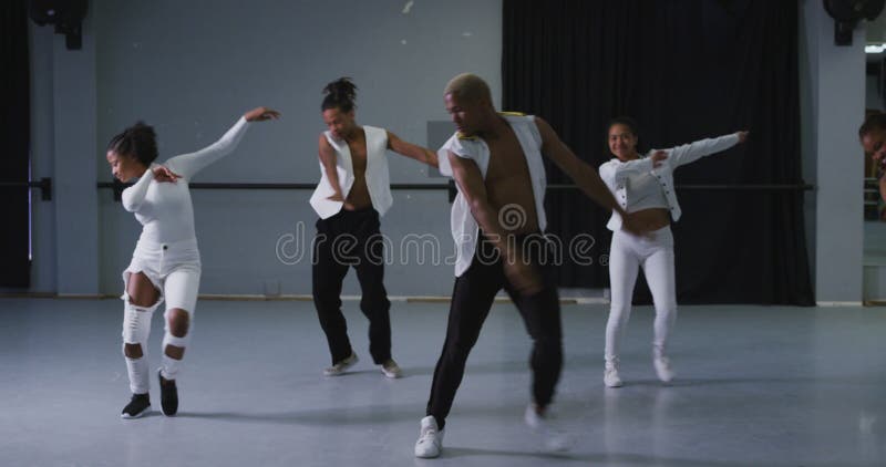 Multi-ethnic Group of Fit Male and Female Modern Dancers Practicing a ...