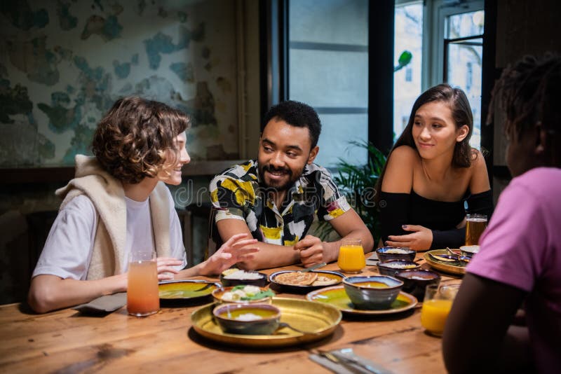 Multi-ethnic Group of Friends Spending Time in a Cafe, Chatting, Stock ...