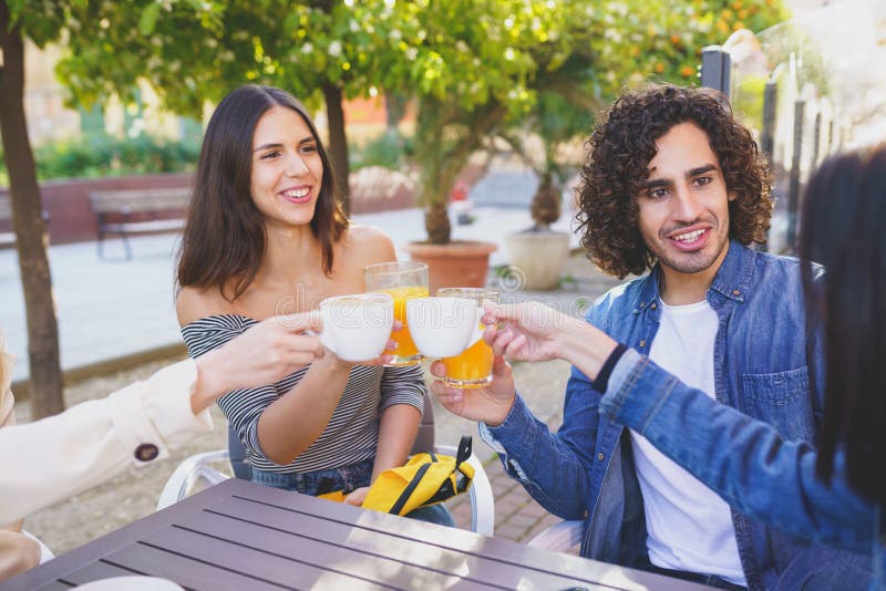 Multi Ethnic Group Friends Toasting Their Drinks Having Drink Together ...