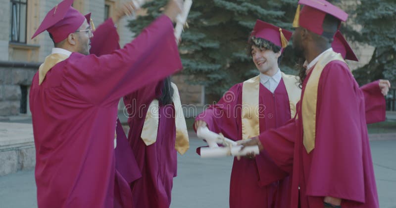 Multi-ethnic Group of Graduates Joining Hands with Diplomas and ...