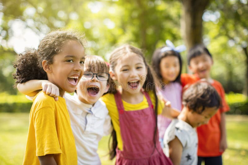 Multiethnic Group of School Children Laughing and Embracing Stock Image ...
