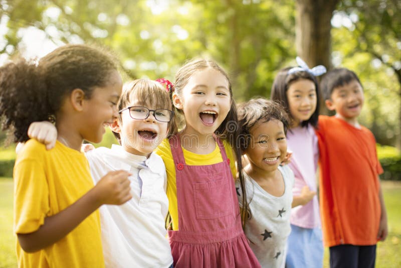 Multiethnic Group of School Children Laughing and Embracing Stock Image ...