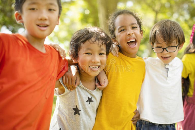 Multiethnic Group of School Children Laughing and Embracing Stock Photo ...