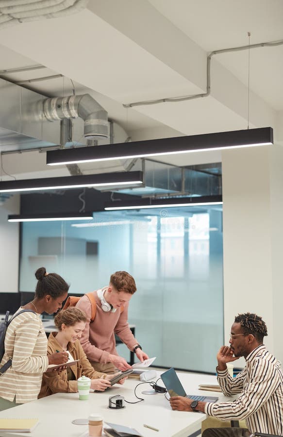 Multi Ethnic Group of Students Working at Table Stock Image - Image of ...
