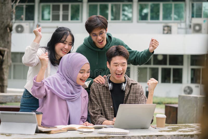 Multi Ethnic Group of University Students Raise Their Arms in ...