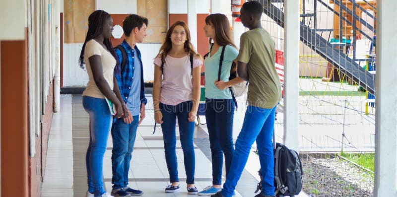 Multi Ethnic Schoolmates Talking in the School Hallway Stock Image ...