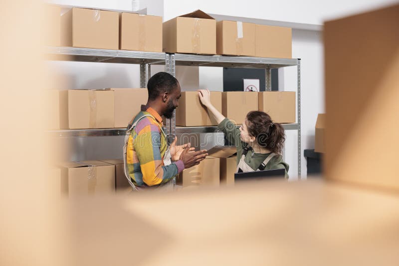 Multi Ethnic Storehouse Team Checking Cardboard Boxes Stock Photo ...