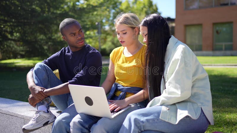 Multi-ethnic Students Sitting Using Mobile in the Campus Stock Footage ...