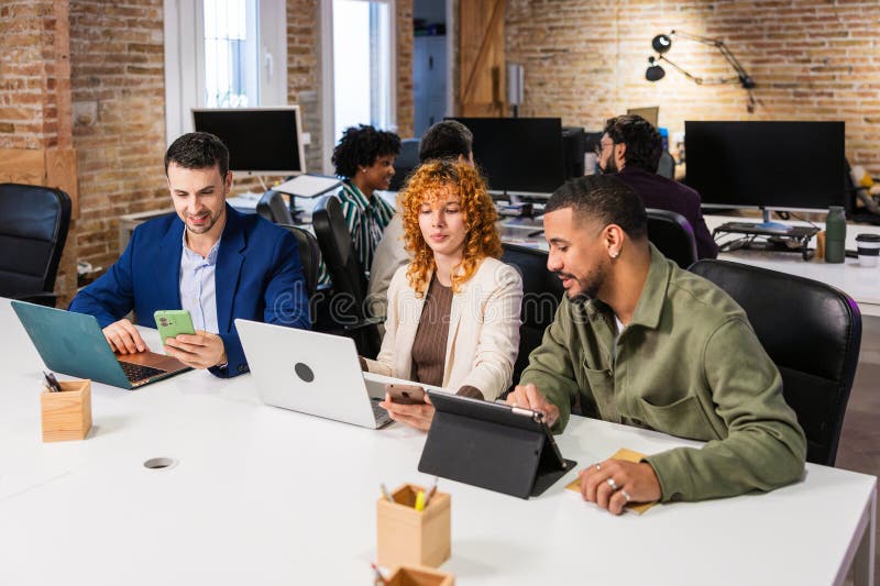Multi Ethnic Team Collaborating on Project in Modern Office Stock Image ...