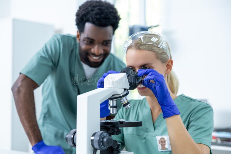 Multi-ethnic Team of Scientists Using Microscope in University Lab Stock Image - Image of ...
