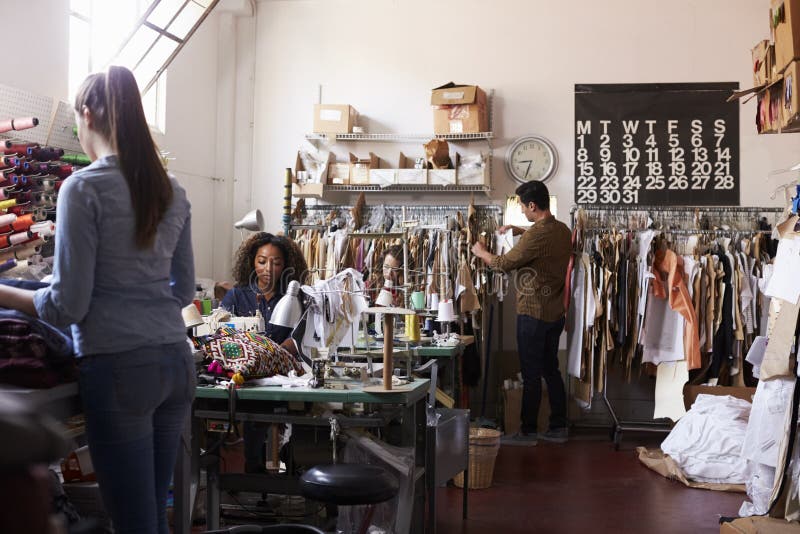 Multi Ethnic Team Working Together in Clothes Design Studio Stock Photo ...