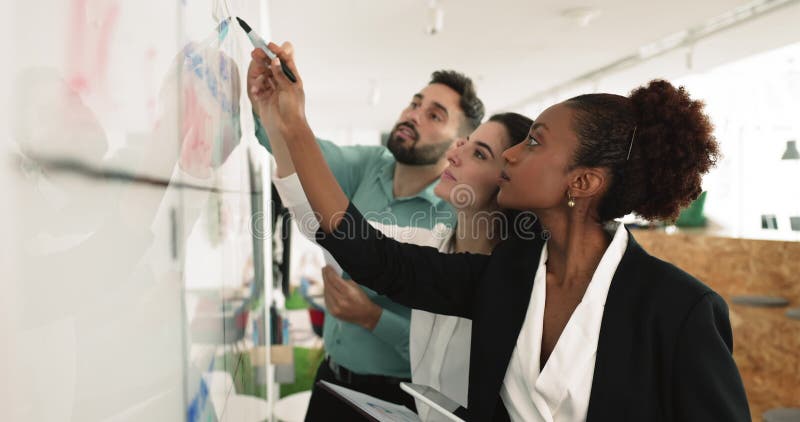 Multi-ethnic Workmates Planning Strategy Standing Near Whiteboard in ...