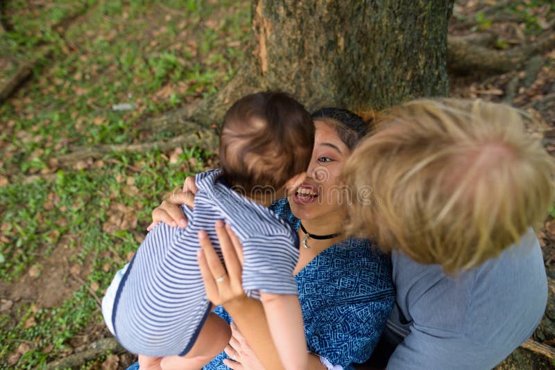 Multi-ethnic Young Family Bonding Together at the Park Stock Photo ...