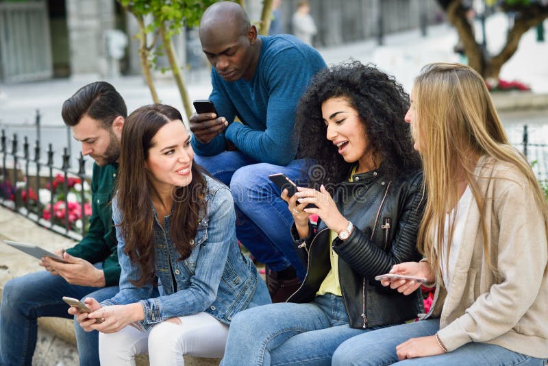 Multi-ethnic Young People Using Smartphone and Tablet Computers Stock ...