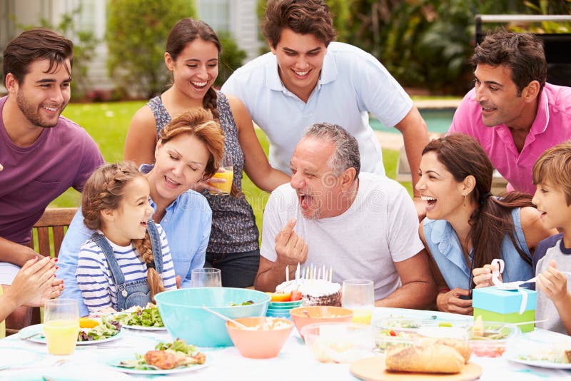 Multi Generation Family Celebrating Birthday in Garden Stock Photo ...