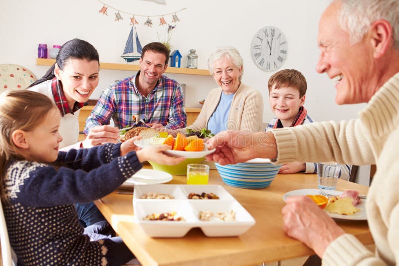 Multi Generation Family Eating Lunch at Kitchen Table Stock Image ...