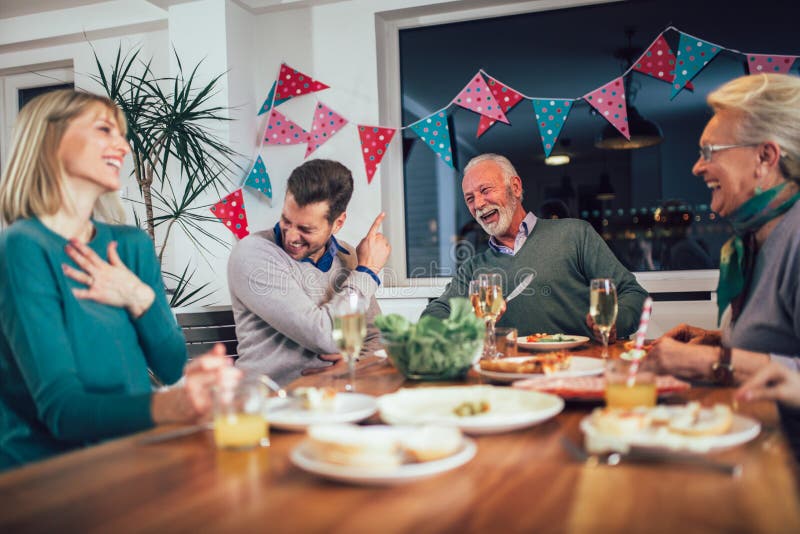 Multi Generation Family Enjoying Meal Around Table Stock Image - Image ...