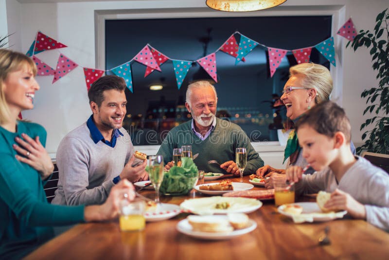 Multi Generation Family Enjoying Meal Around Table Stock Image - Image ...