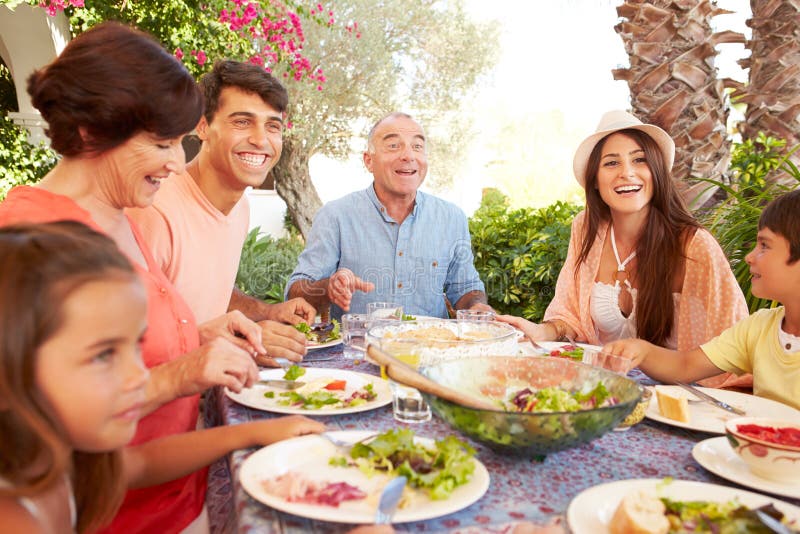 Multi Generation Family Enjoying Meal on Terrace Together Stock Photo ...