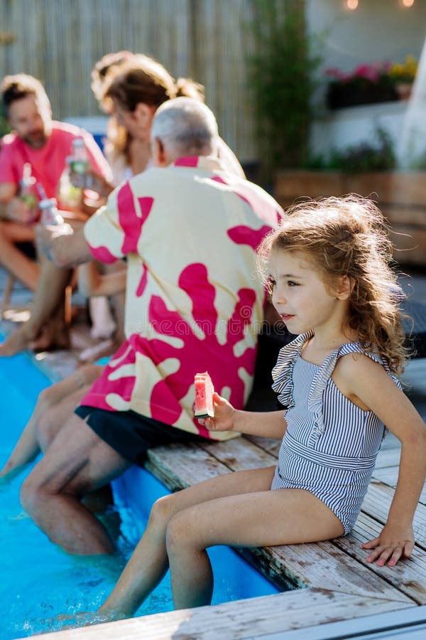 Multi Generation Family Enjoying Summer Time, Sitting at Backyard Pool ...