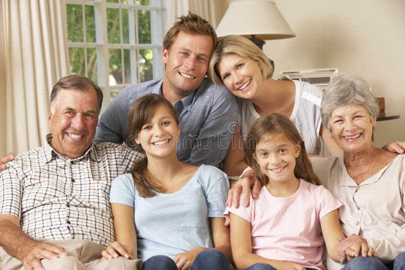 Multi Generation Family Group Sitting on Sofa Indoors Stock Photo ...