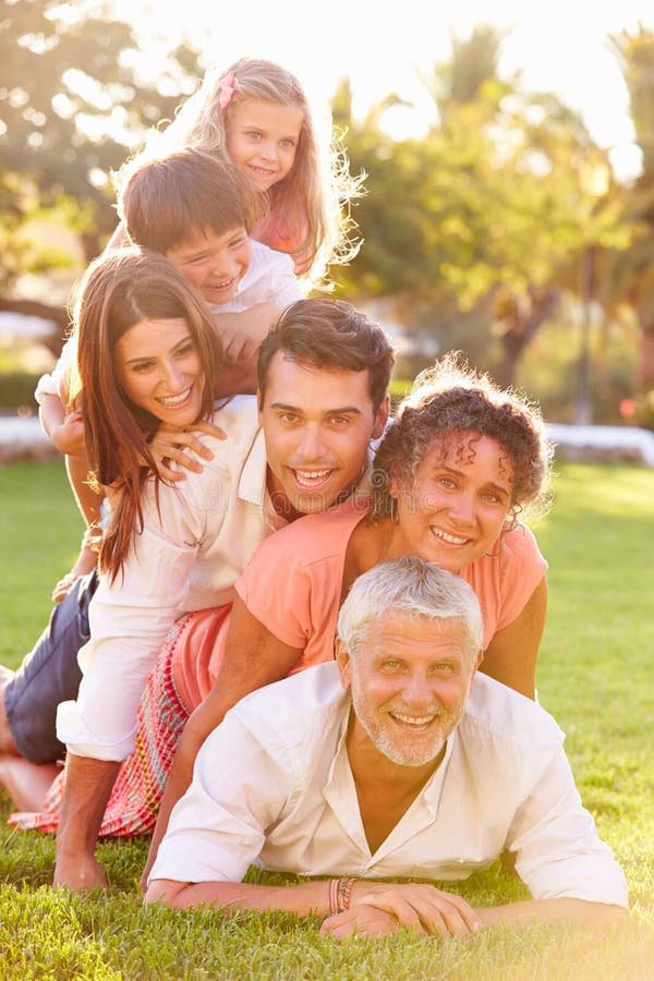 Multi Generation Family Lying in Pile Up on Grass Together Stock Image ...