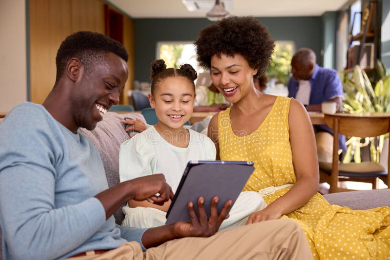 Multi-Generation Family with Parents Using Digital Tablet with Daughter ...