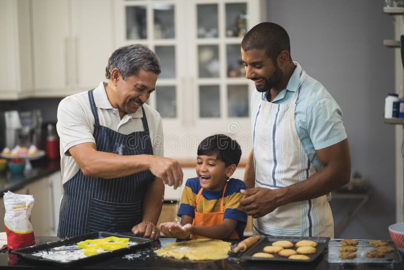 Multi-generation Family Preparing Food in Kitchen Stock Photo - Image ...
