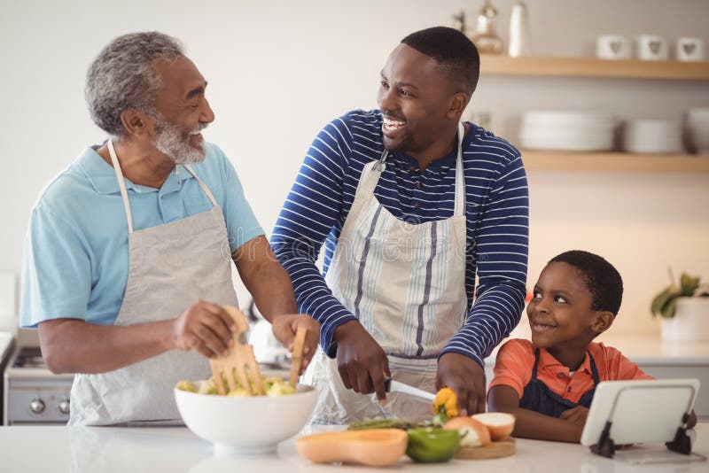 Multi-generation Family Preparing Food in Kitchen Stock Photo - Image ...