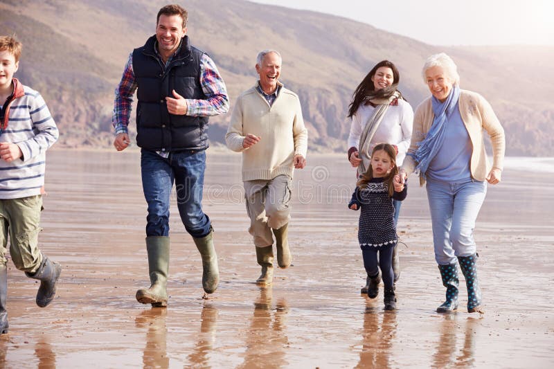 Multi Generation Family Running on Winter Beach Stock Image - Image of ...