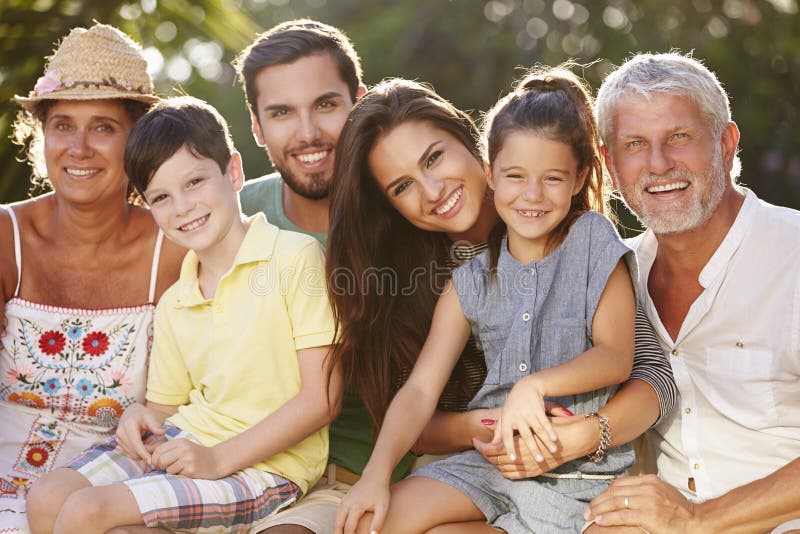 Multi Generation Family Sitting in Garden Together Stock Photo - Image ...