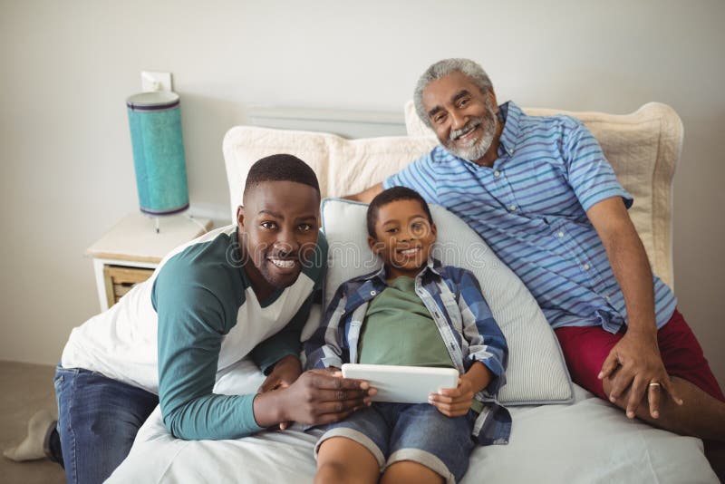 Multi-generation Family Using Digital Tablet on Bed Stock Photo - Image ...