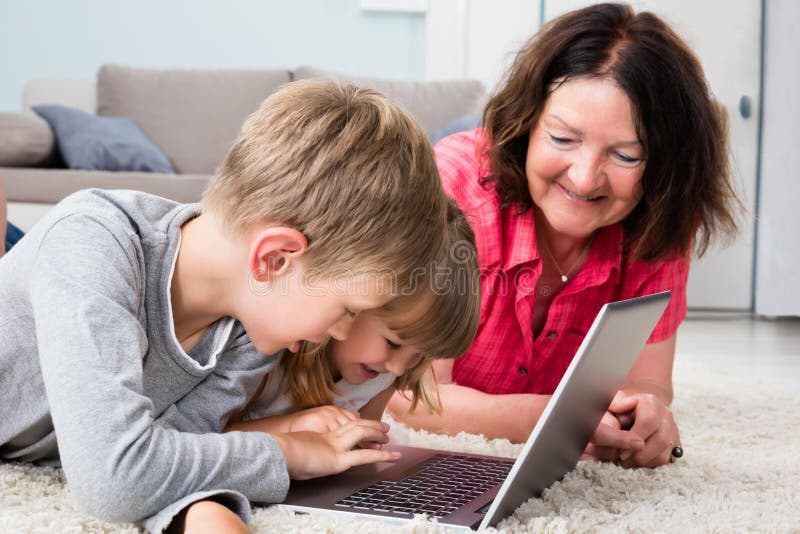 Multi Generation Family Using Laptop at Home Stock Image - Image of ...