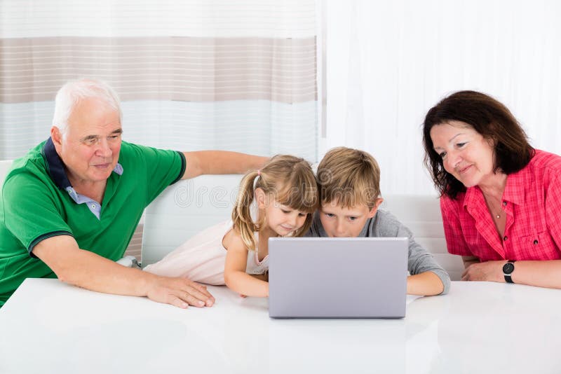 Multi Generation Family Using Laptop at Home Stock Image - Image of ...