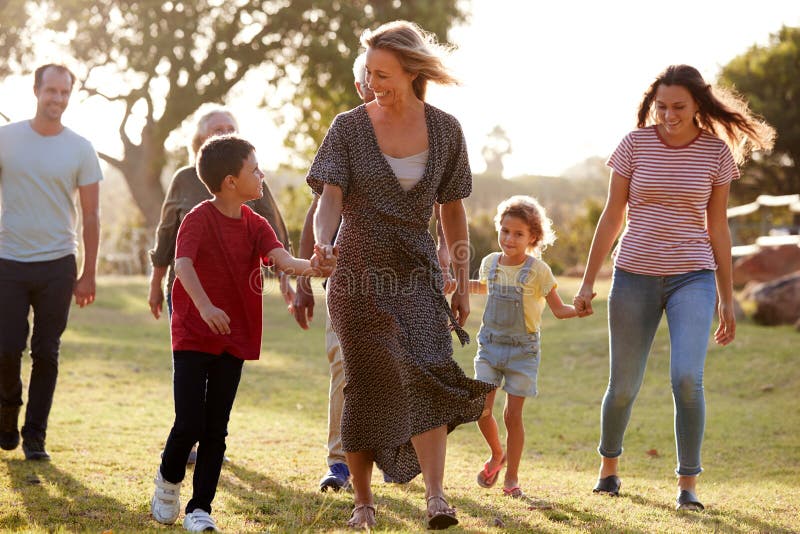 Multi-Generation Family Walking in Countryside Against Flaring Sun ...