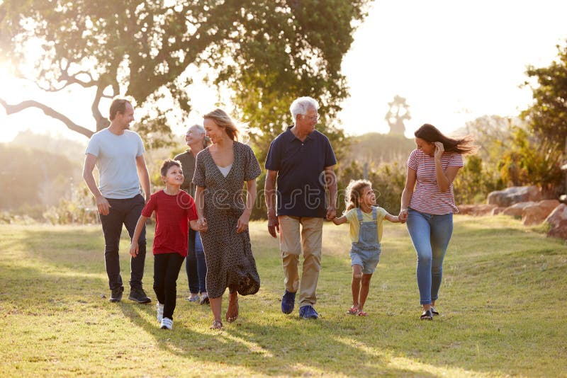Multi-Generation Family Walking in Countryside Against Flaring Sun ...