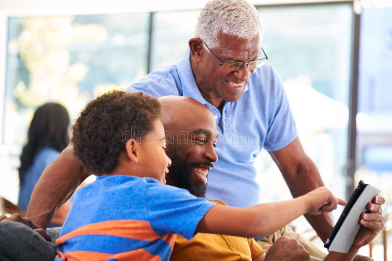 Multi-Generation Male African American Family Sitting on Sofa at Home ...